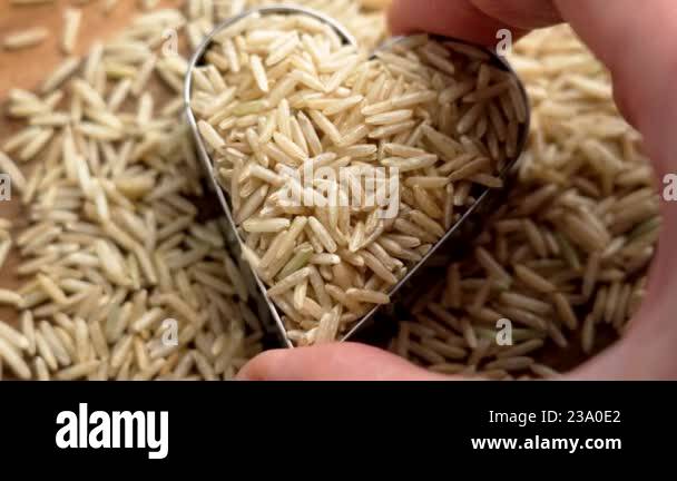 Gourmet hand taking heart shaped steel form from pile of uncooked ...