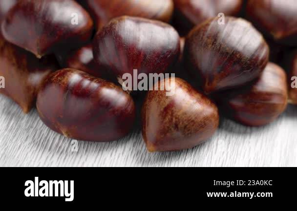 Organic chestnuts on aged rustic white board. Macro. Rotation Stock ...