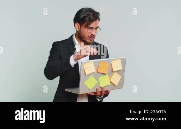 Exhausted Indian businessman with pasted sticker notes use laptop ...