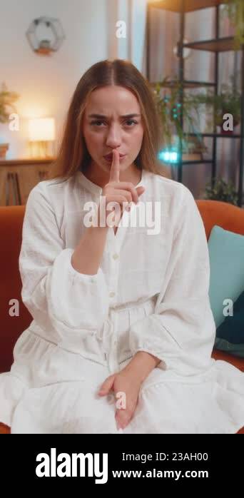 Shh be quiet please, silent. Portrait of young woman presses index ...