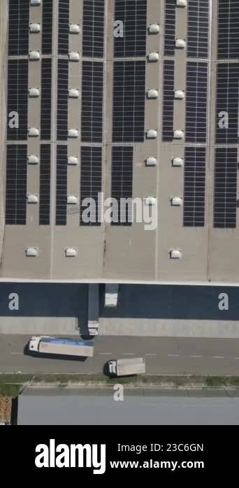 Vertical Screen: Aerial view of a logistics center with solar panels on ...