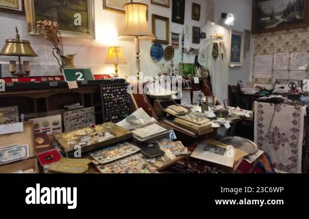 Vintage shop filled with antique objects including lamps, postcards ...