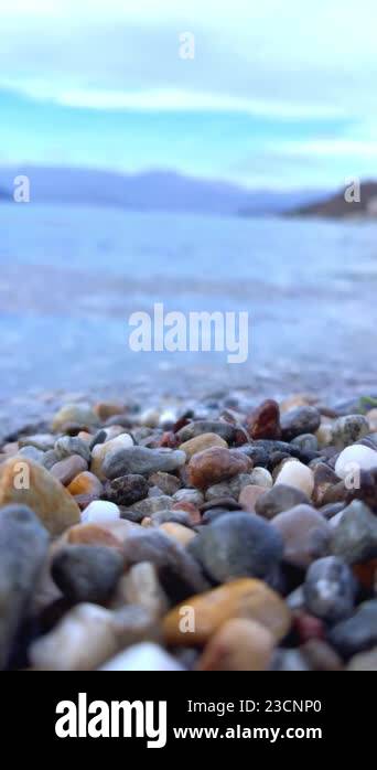 Beautiful rocks on Lake Como in Italy. Waves and view of the Alps Stock ...