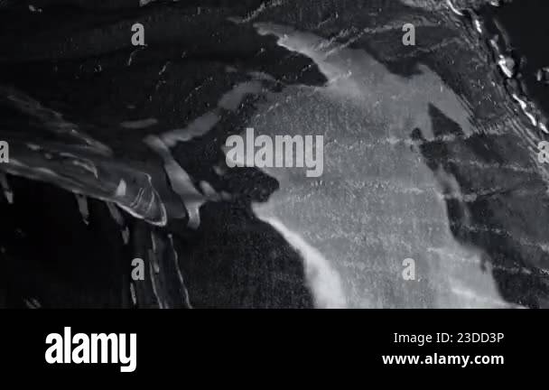 Super Slow Motion Detail Shot of Water Splashing on Waterproof Black ...