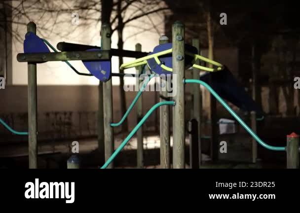 A playground with a blue and yellow slide. The playground is empty and ...