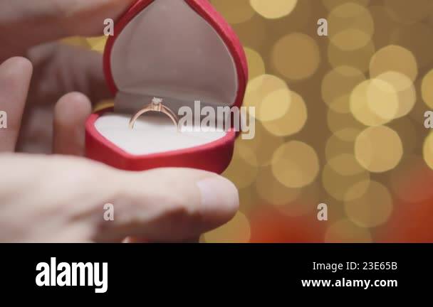 Inside a heartshaped, red velvet box lies a stunning engagement ring ...