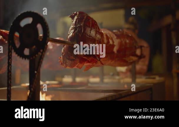 pigs roasting on fire pit and turning Stock Video Footage - Alamy