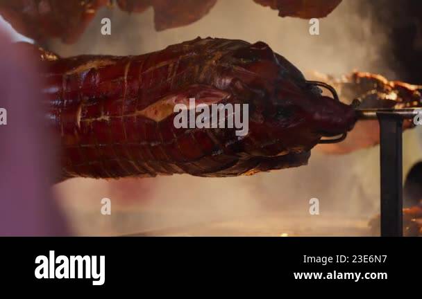 pigs roasting on fire pit and turning Stock Video Footage - Alamy