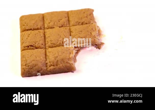 A close-up shot of a light brown fudge bar, sectioned into sixteen ...