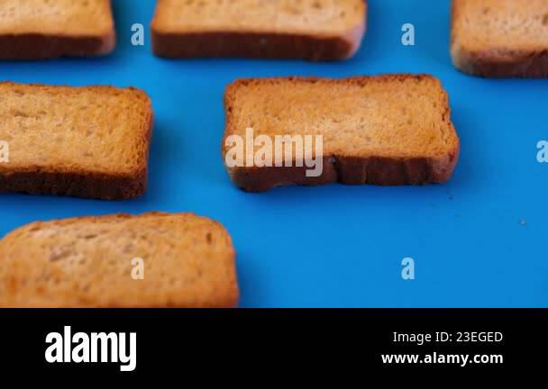Multiple slices of toasted bread are neatly placed against a bright ...
