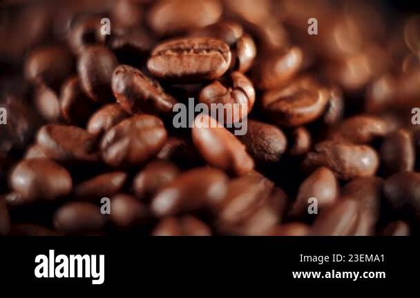 Close-up view of rotating coffee beans showcasing rich texture on a ...