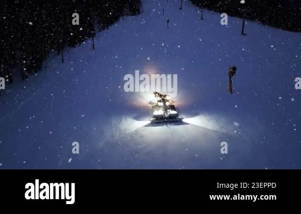 Aerial view of working snowcat on snowy alpine ski slope at winter ...