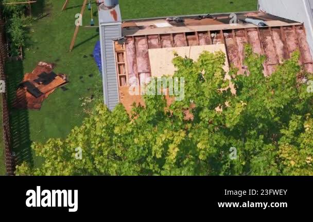 Roofers installing a new roof on an residential building. drone view ...