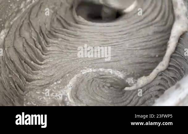 A mixture of concrete is being prepared at a construction site ...