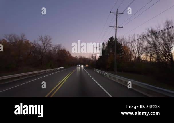 Driving in on the road at evening time. Wide POV wide view shot. High ...