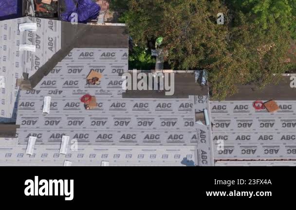 Roofers installing a new roof. Aerial wide view. Naperville IL. USA. 2 ...