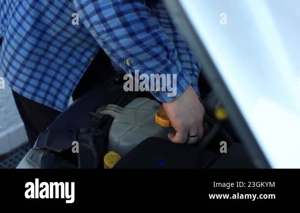 Mans Hands Using Tools to Repair a Car Engine Beneath the Open Hood ...