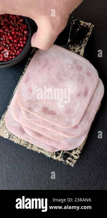Boiled ham with salt and spices cut into slices on dark concrete ...