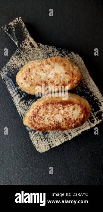 Delicious fresh fried minced fish cutlets with spices and herbs on a ...