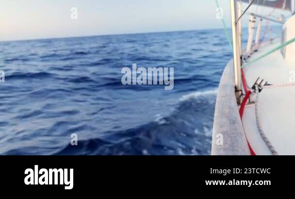 Port side a sailboat cutting trough the ocean while crossing the Bay of ...