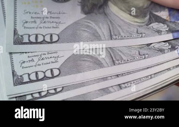 A detailed and upclose view of multiple hundred dollar bills ...