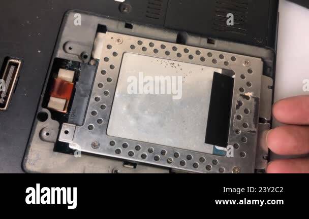 Professional technician removes laptop hard drive for repair. Computer ...