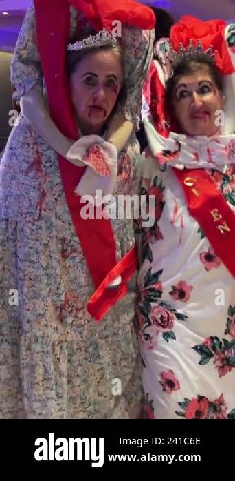 two headless women siamese twins mask in jacket looking at camera ...