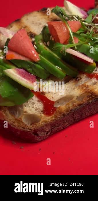 Healthy food. Bread toast with avocado and strawberry on plate, closeup ...