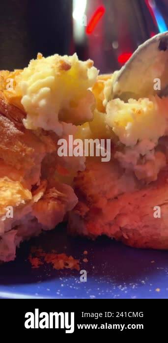 buttery delicious texture of round croissant puff pastry cut with spoon ...