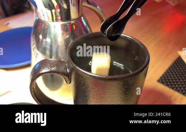 throwing refined sugar into a cup of tea. High quality 4k footage Stock ...