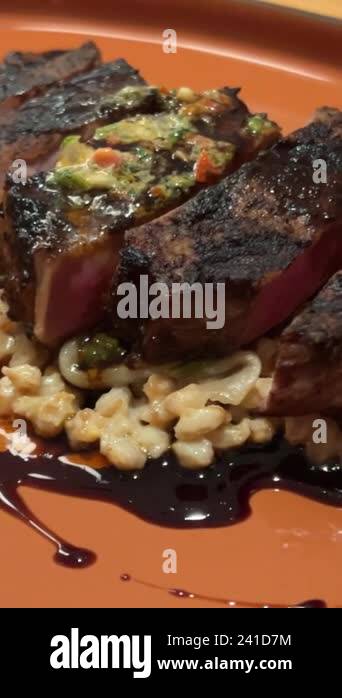 cook pours sauce over cooked beef steak, close-up. High quality 4k ...