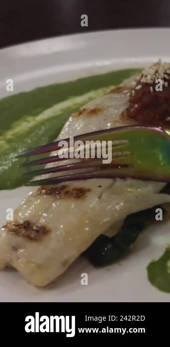 finely decorated fried white fish piece with mashed potatoes and ...