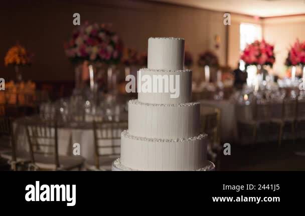 A stunning multi-tiered white wedding cake decorated with intricate ...