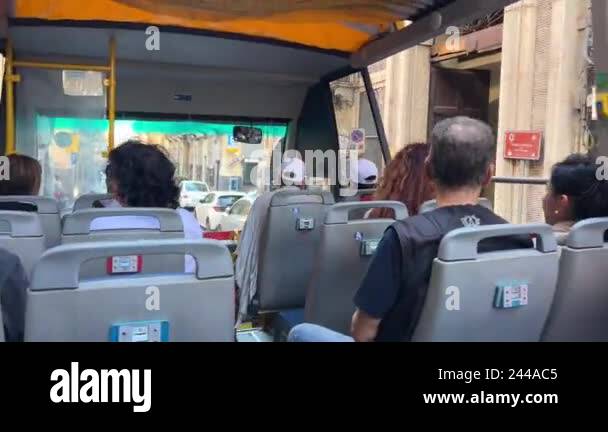 Adult travelers ride on a double-decker tour bus people tourists on a ...