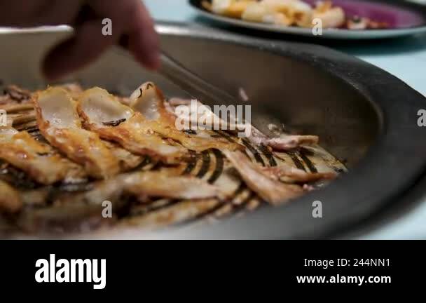 Frying bacon slices in pan, close up. Crispy pieces of delicious Bacon ...