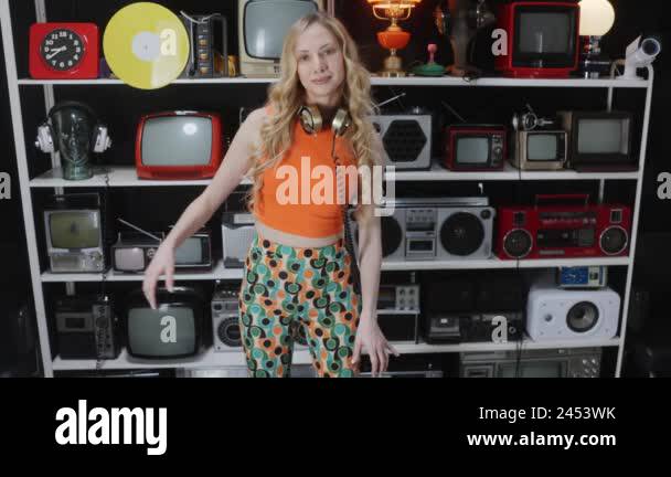 Party Woman dancing With Televisions and retro objects in background ...