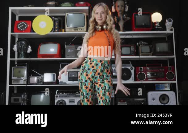 Party Woman dancing With Televisions and retro objects in background ...