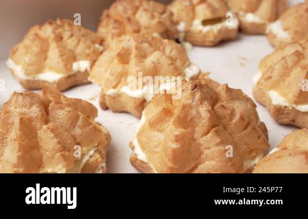 Tray of cakes with white filling. The pastries are small, round, laid ...