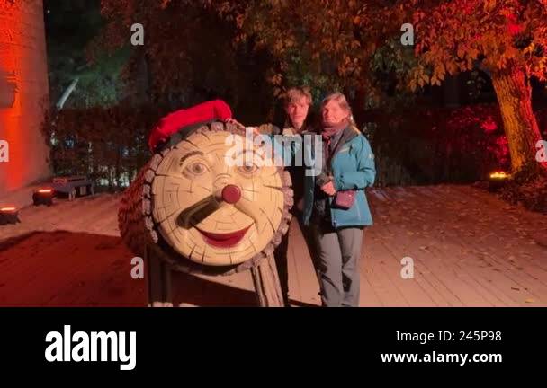 Tourists capturing memorable moments with illuminated Pinocchio log ...