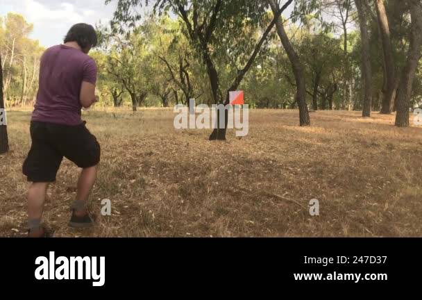 Athlete navigating with map and compass, reaching a checkpoint during ...