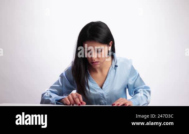 Latin businesswoman signing important documents at her desk, slow ...