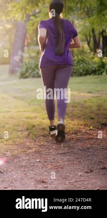 Latin female runner enjoying fitness session during golden hour, moving ...