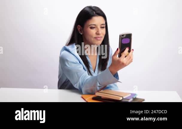 Businesswoman making a video call with concerned expression on a white ...
