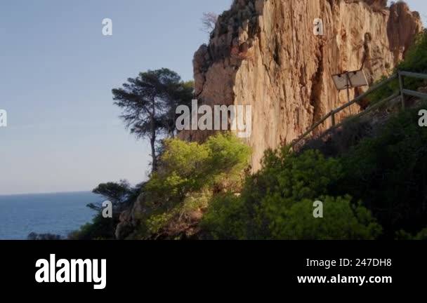 a stone cliff in the warm sunset light against the background of the ...