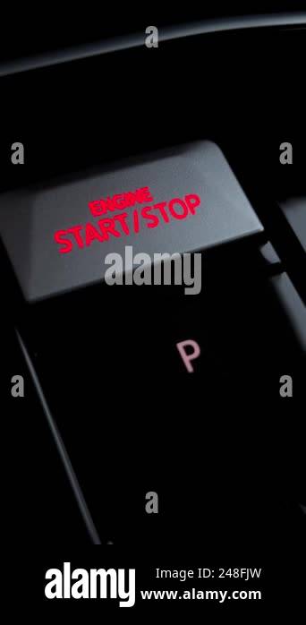 Starting car engine. Vertical shot of start stop engine button. Modern ...