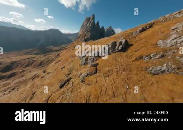 FPV drone flying close to the sharp mountain cliffs of Seceda, Italy ...