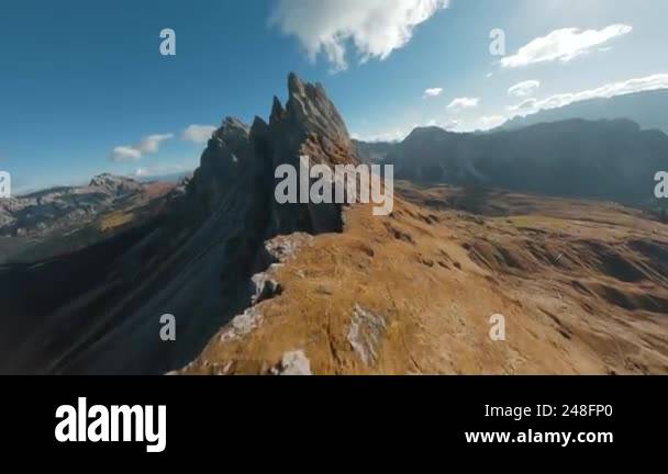 FPV drone flying close to the sharp mountain cliffs of Seceda, Italy ...