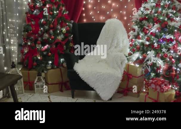 A cozy Christmas setup with decorated trees, glowing lights, wrapped ...