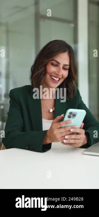 Happy Mexican businesswoman sit at table in modern workspace with ...