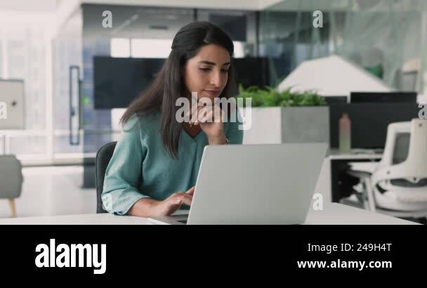 Focused businesswoman, corporate staff member using laptop seated at ...